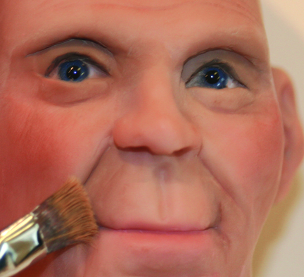 Painting the face and correcting errors.
