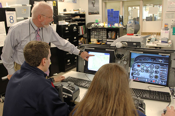 Engineering teacher Karl Ruff works with Aerospace Engineering students ...