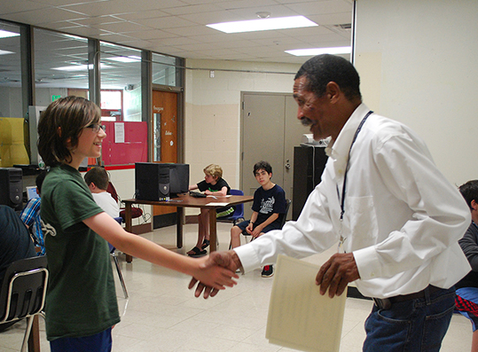 Tech Center teacher Douglas Geer congratulates a camper upon completion
