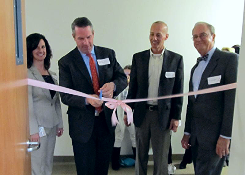 IIVS officers and Michael Ellis, son of William Ellis, cut the ribbon ...